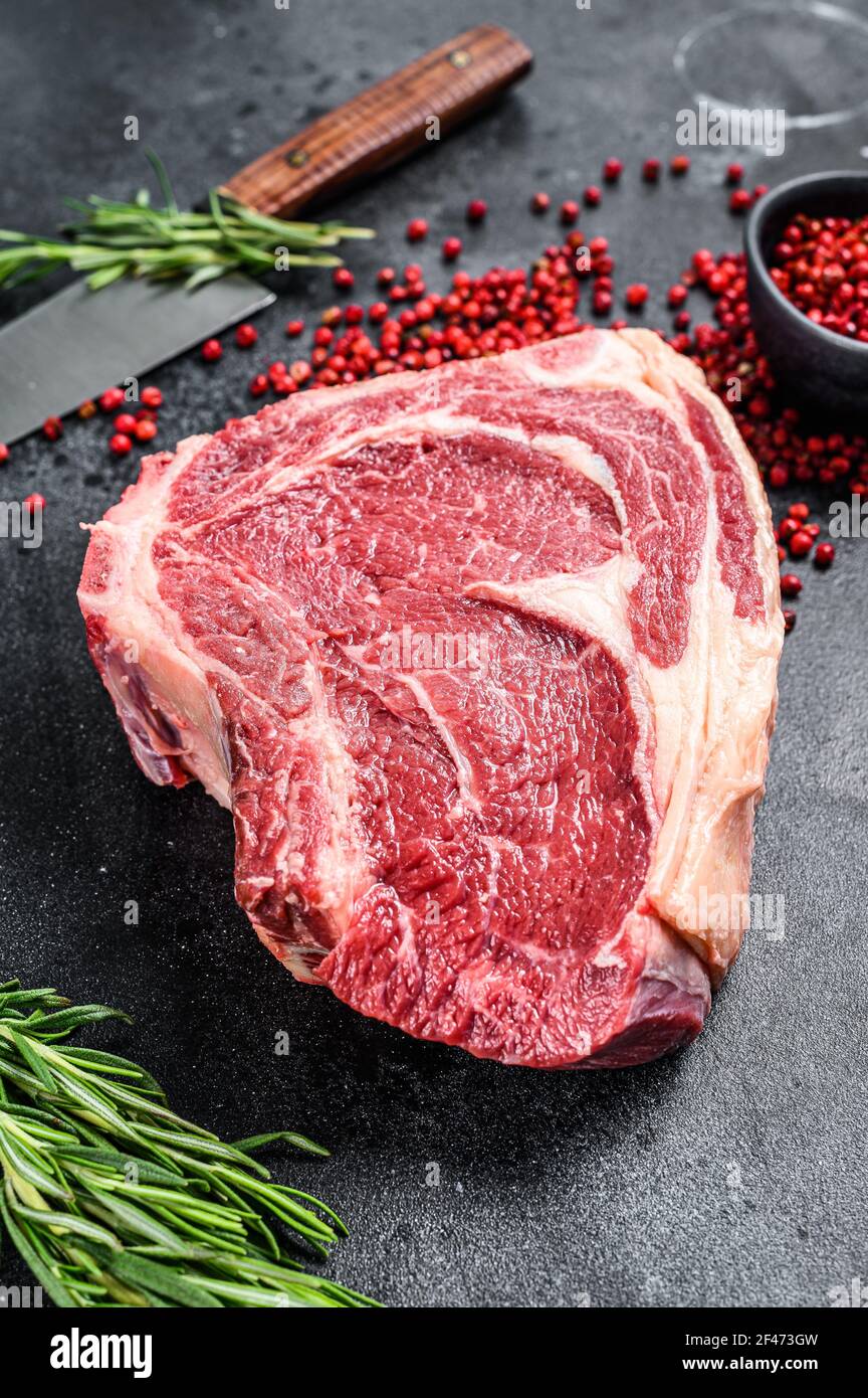 Ribeye on the bone or cowboy steak. Raw Marble beef. Black background ...