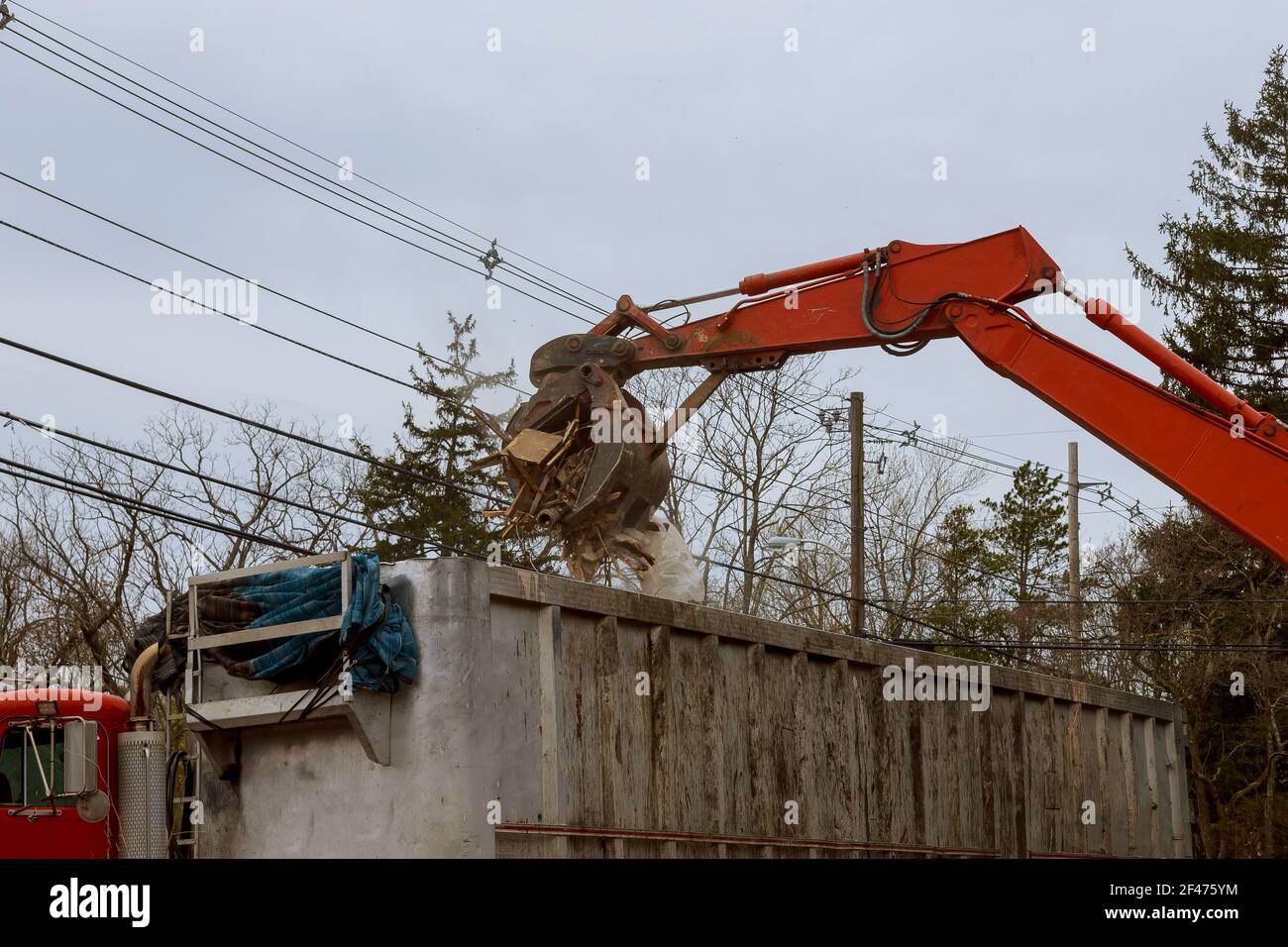 A bulldozer destroys of the demolition of a building under construction ...