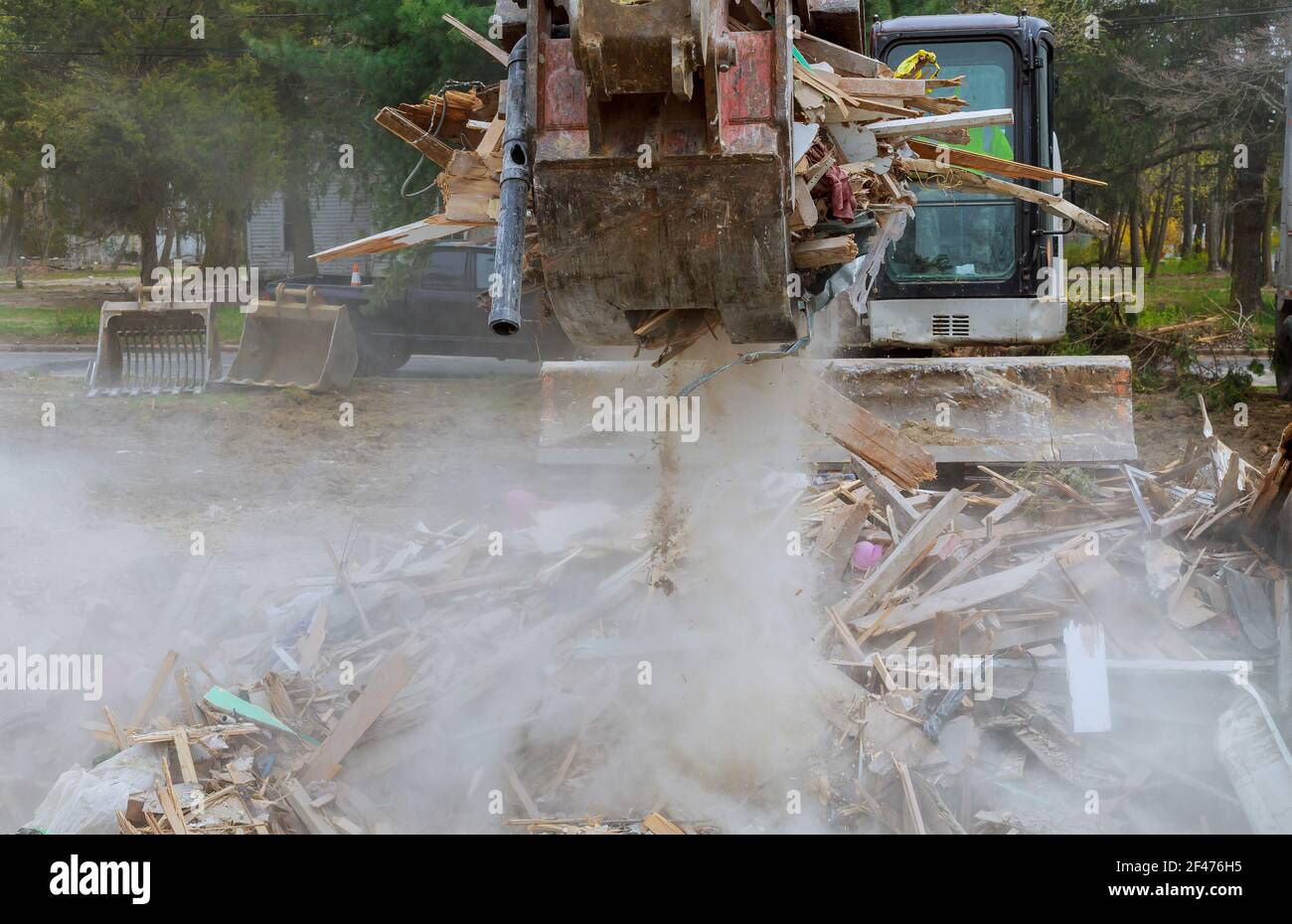 Demolition of wooden house in trash debris outside of neighborhoods ...
