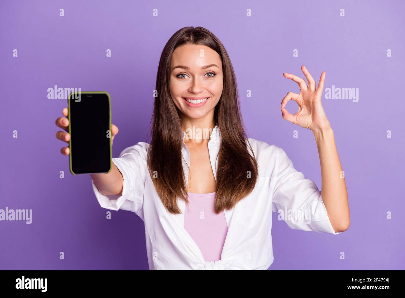 Photo of lady hold smartphone screen empty space show okey sign wear ...