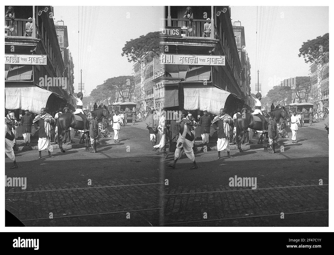Bombay (?) (India). Street scene on a junction or intersection with a ...
