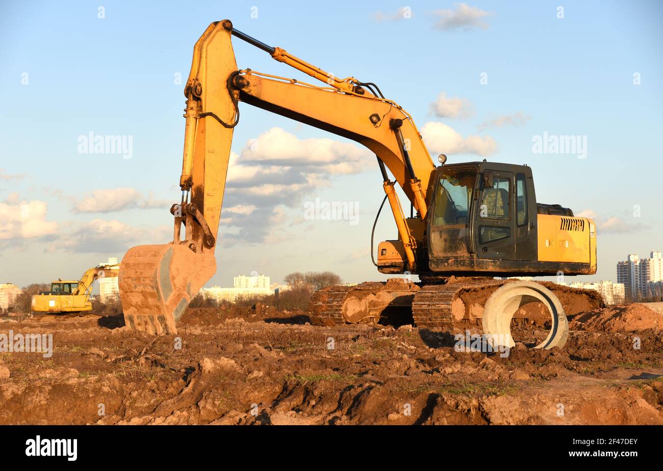 Excavator dig the trenches at a construction site. Trench for laying ...