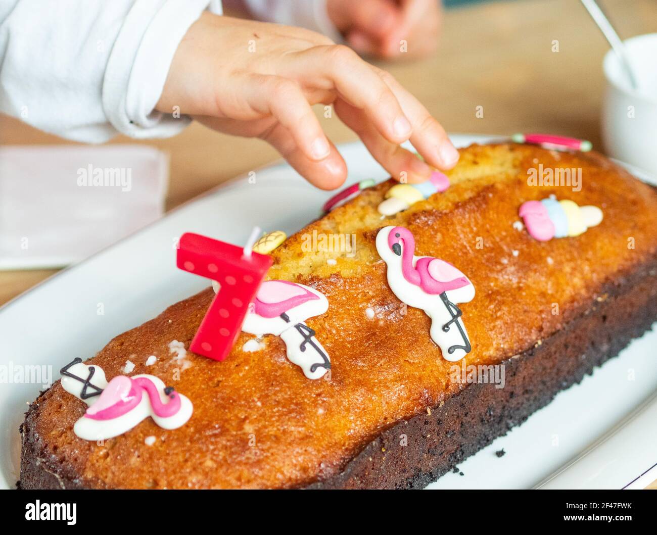 Child helping to prepare and decorate a birthday cake Stock Photo - Alamy