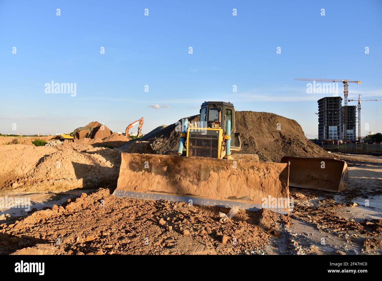 Dozer and excavator on earthmoving at construction site. Construction ...