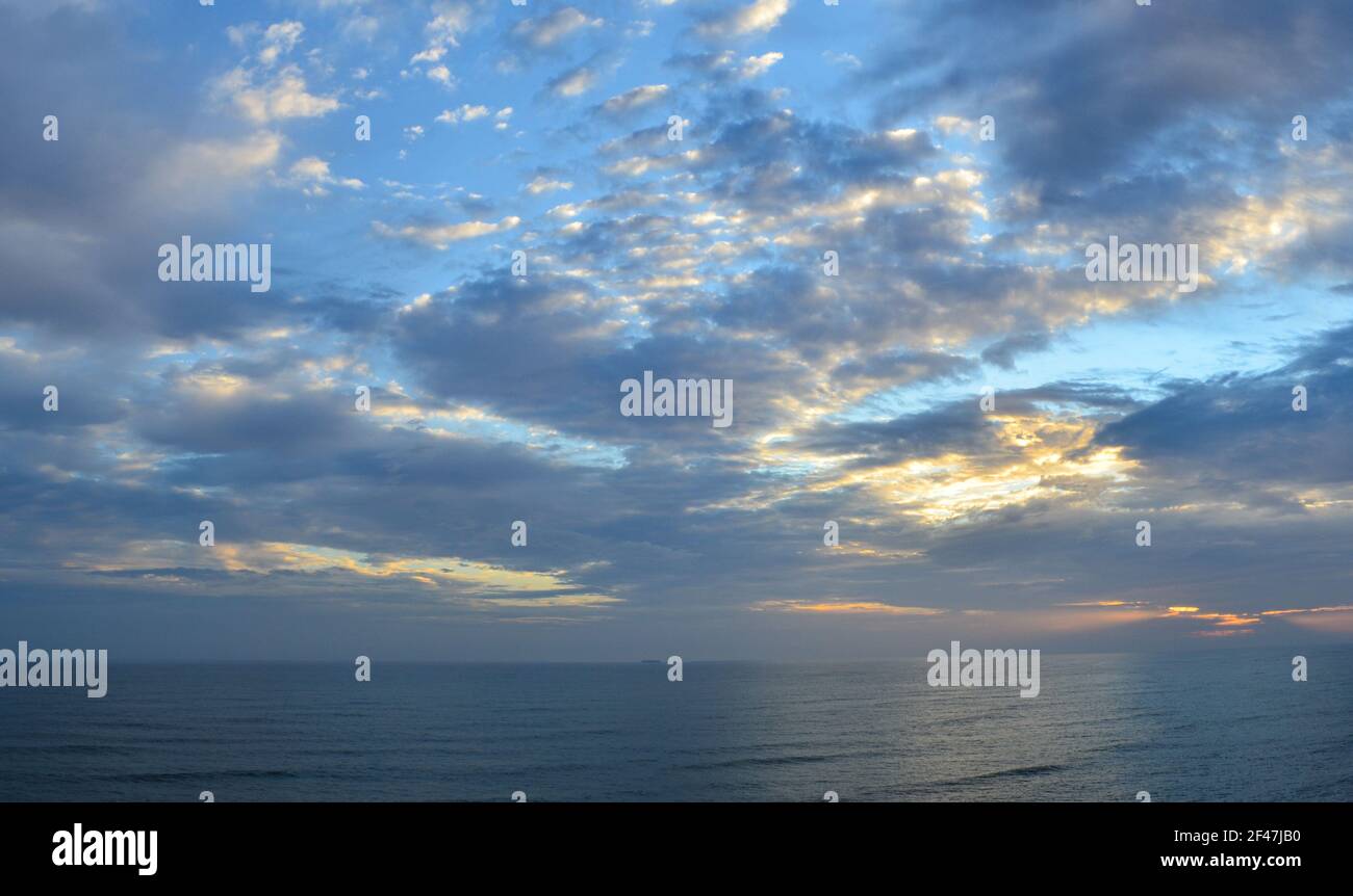A landscape of the sea under the sunlight and a blue cloudy sky during ...