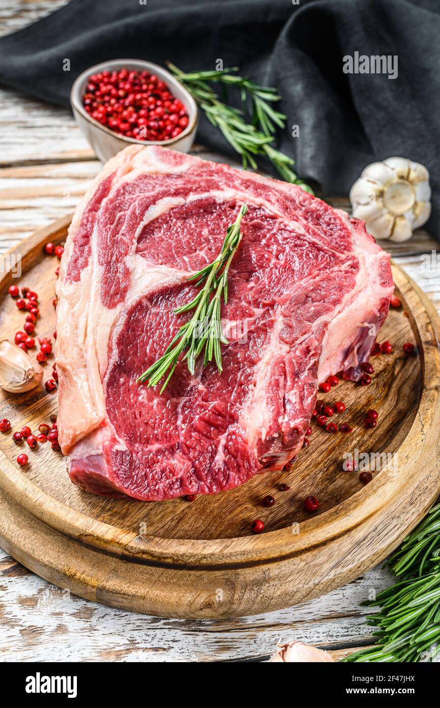 Rib-eye on the bone or cowboy steak. Raw Dallas beef steak. White ...
