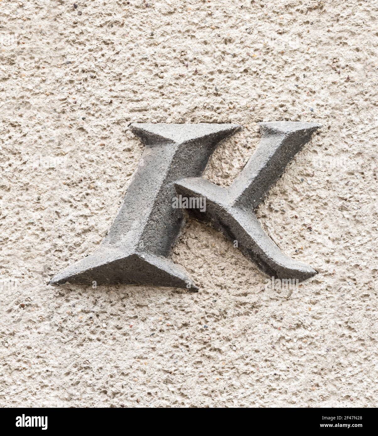 Capital letter K on roughly plastered wall Stock Photo - Alamy