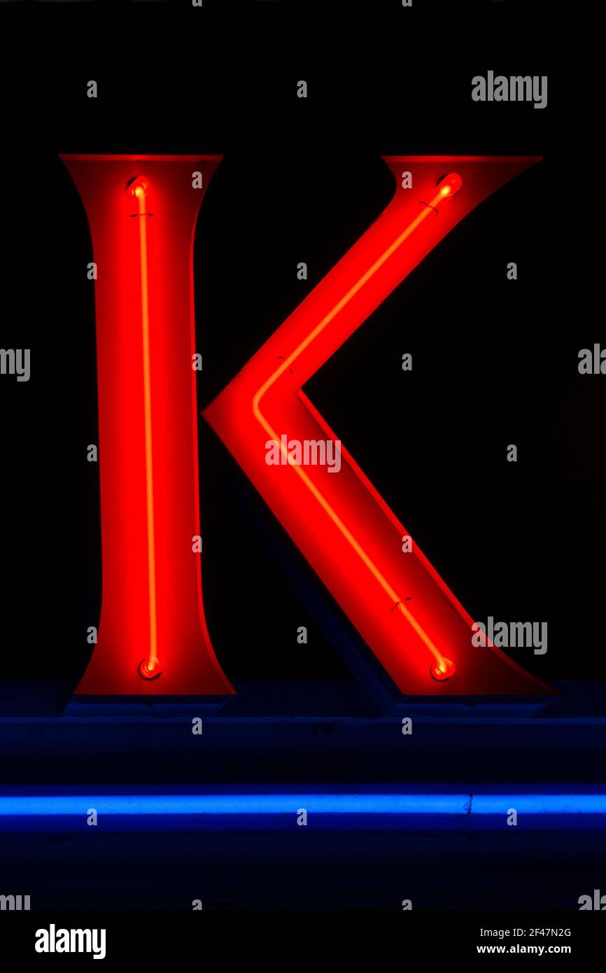 Red glowing neon letter K at night with blue underline Stock Photo - Alamy