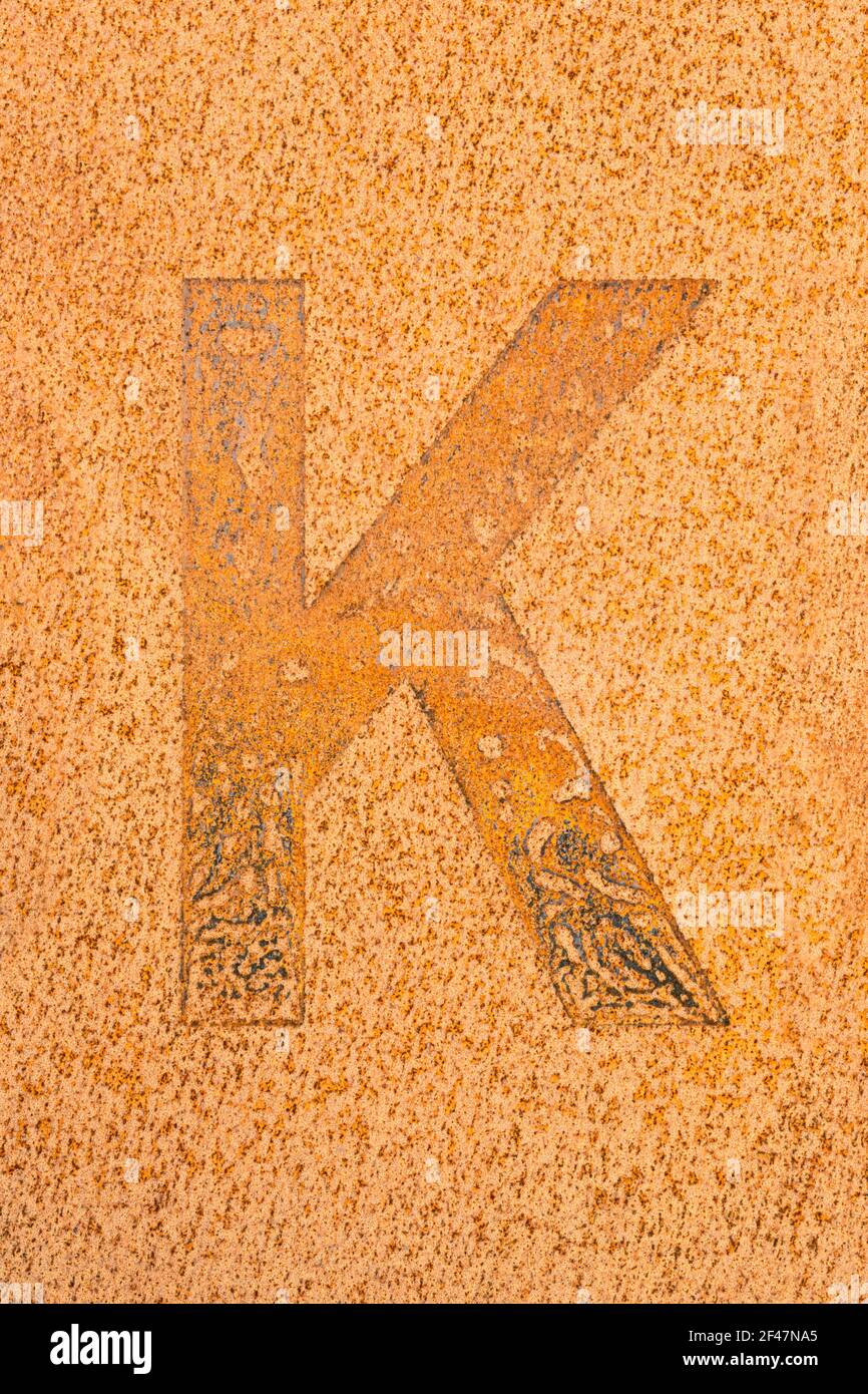 Remains of a letter K on a rusted metal plate Stock Photo - Alamy