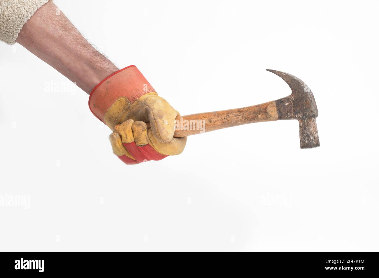 A gloved workmans hand holding a well used claw hammer Stock Photo - Alamy