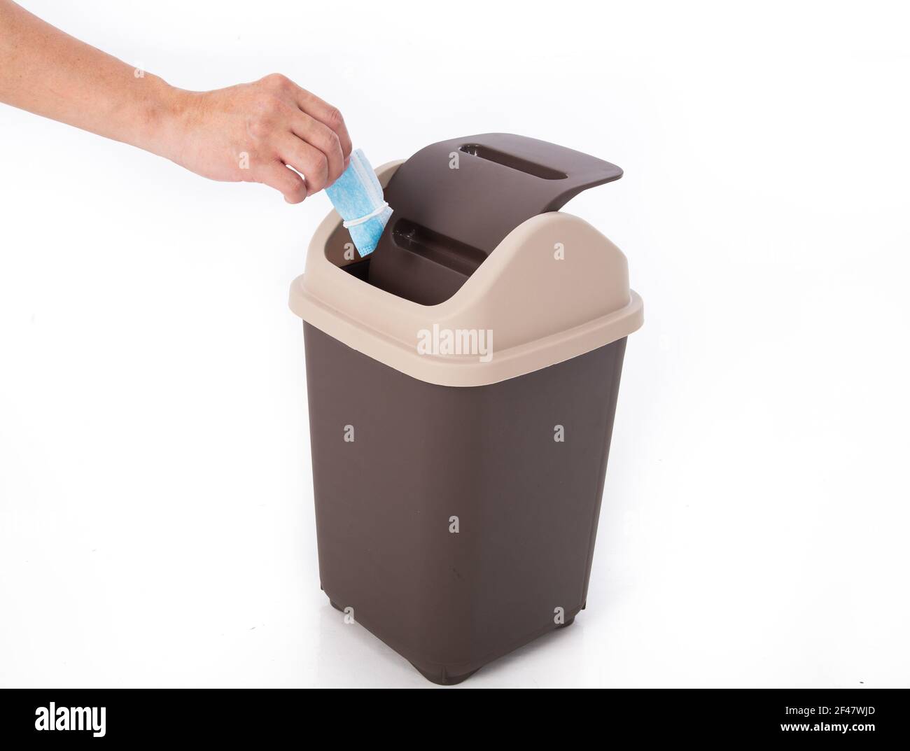 Hand Throw surgical mask in the trash. Disposable surgical mask on ...
