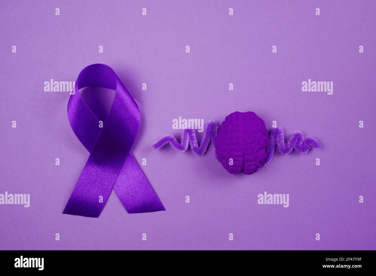 Purple day. World epilepsy day. Purple ribbon and brain on purple ...