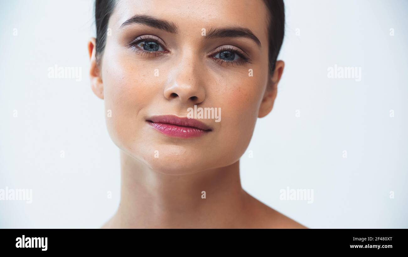 portrait of young woman with perfect face looking at camera isolated on ...