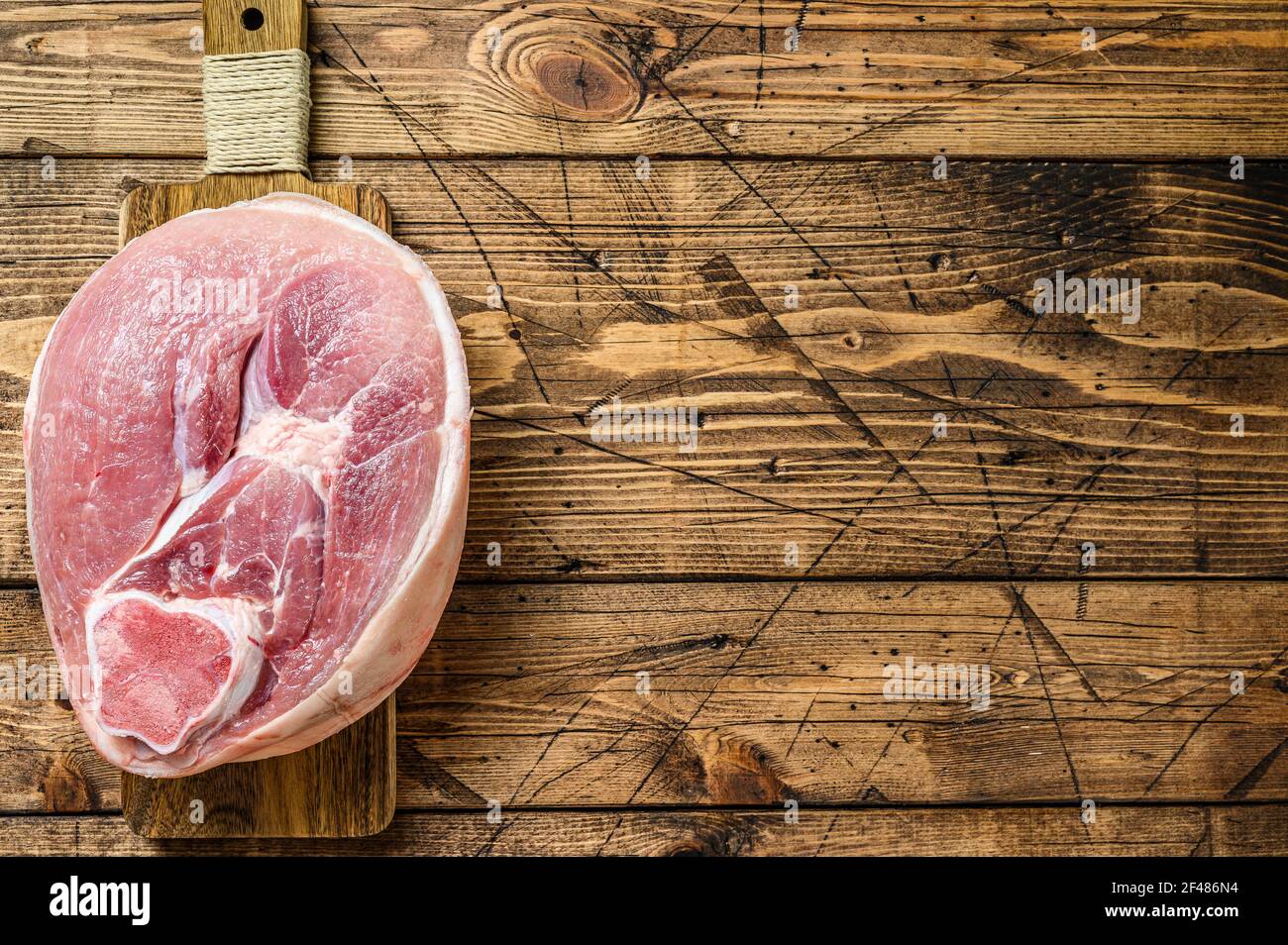 Slice of raw pork knuckle, leg. Farm fresh meat. Wooden background. Top ...