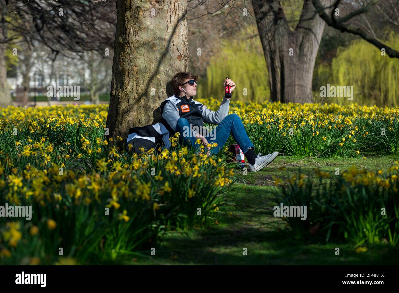 London, UK. 19 March 2021. UK Weather – A man drinking beer sits ...