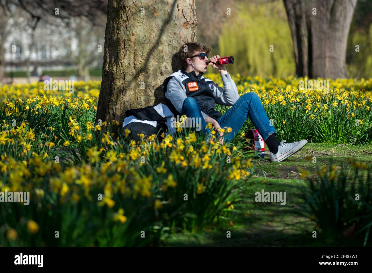 London, UK. 19 March 2021. UK Weather – A man drinking beer sits ...