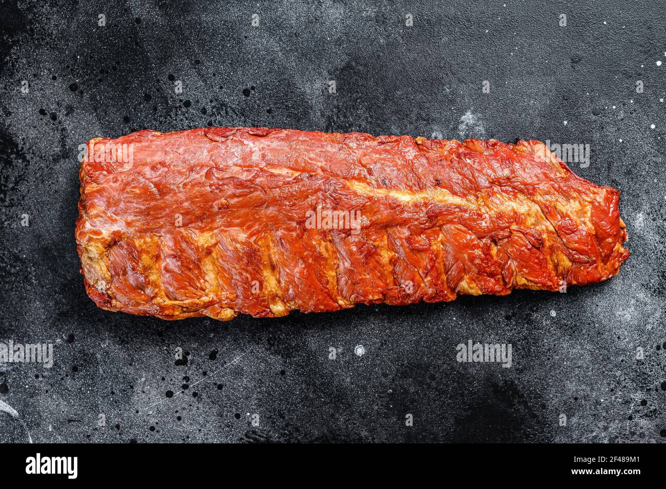 Smoked pork ribs in barbecue sauce. Black background. Top view Stock ...