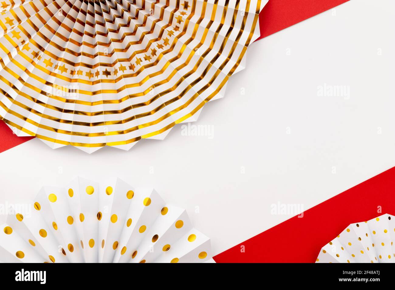 White and golden paper fans on white background. Party, decorations ...