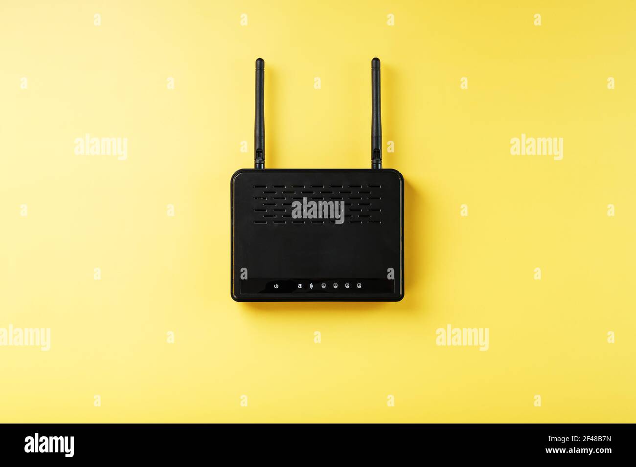 Black Wi-Fi router on a yellow background with free space. Isolate, top ...