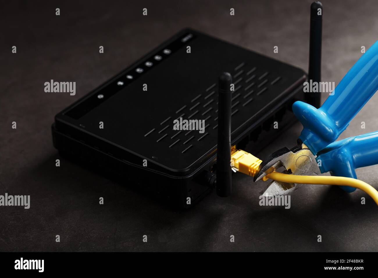 Tearing and cutting with blue wire cutters the network connection of ...