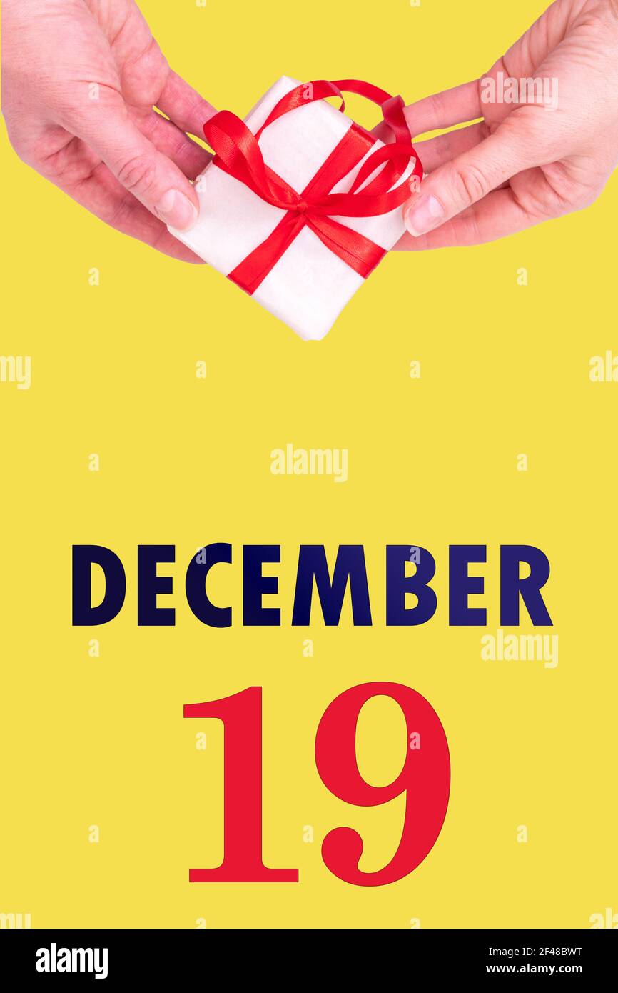 December 19th. Festive Vertical Calendar With Hands Holding White Gift ...