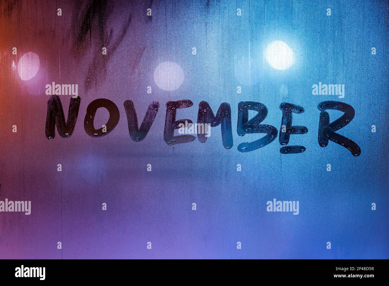 the word november handwritten on night wet window glass surface Stock ...