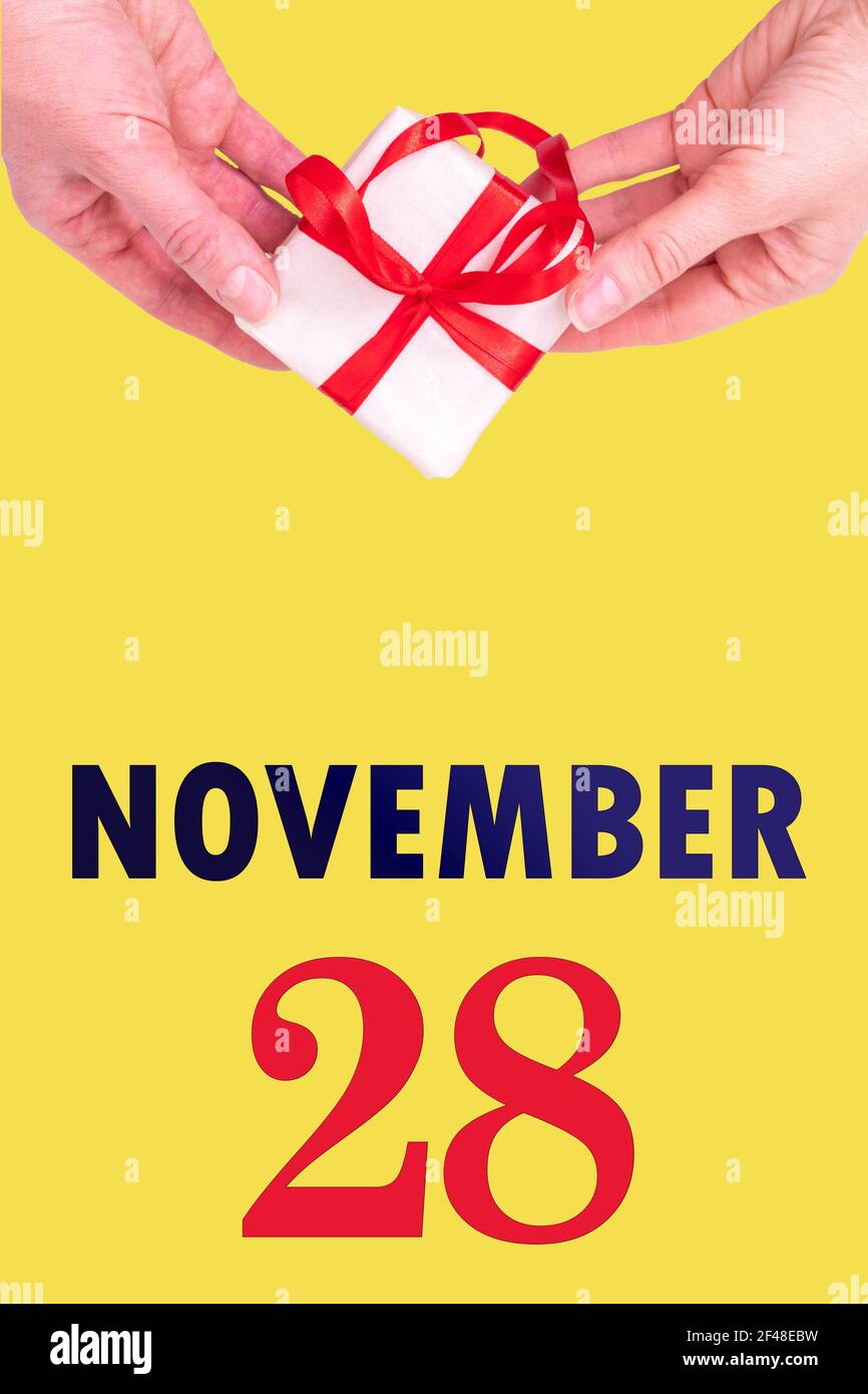 November 28th. Festive Vertical Calendar With Hands Holding White Gift ...