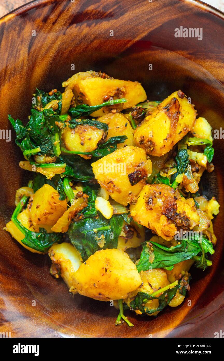 Indian saag aloo, potato and greens curry dish Stock Photo - Alamy