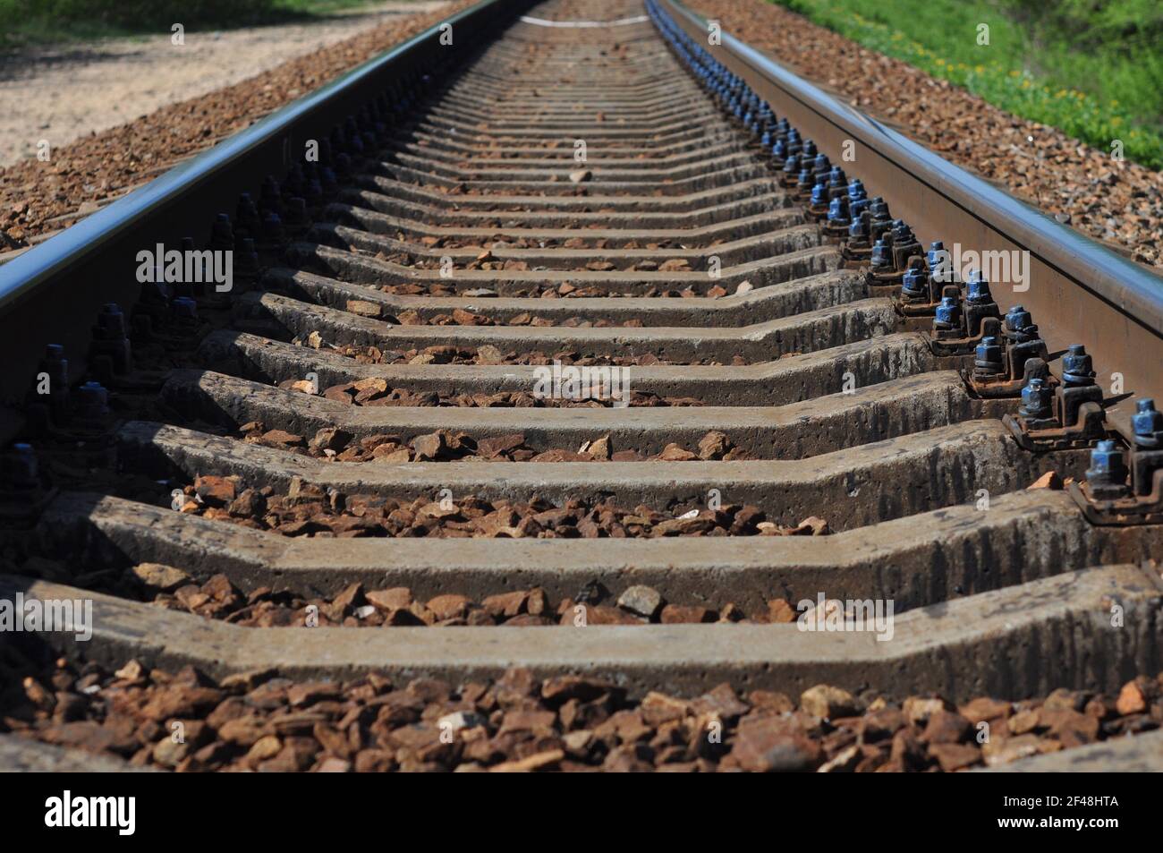 Train tracks off into the distance. Railway rails and road-metal Stock ...
