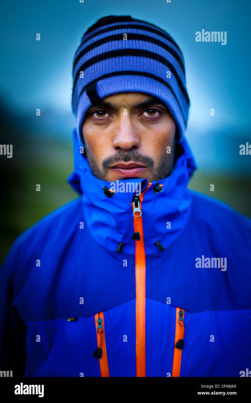 A shallow focus of a handsome Spanish male wearing a stylish blue ...