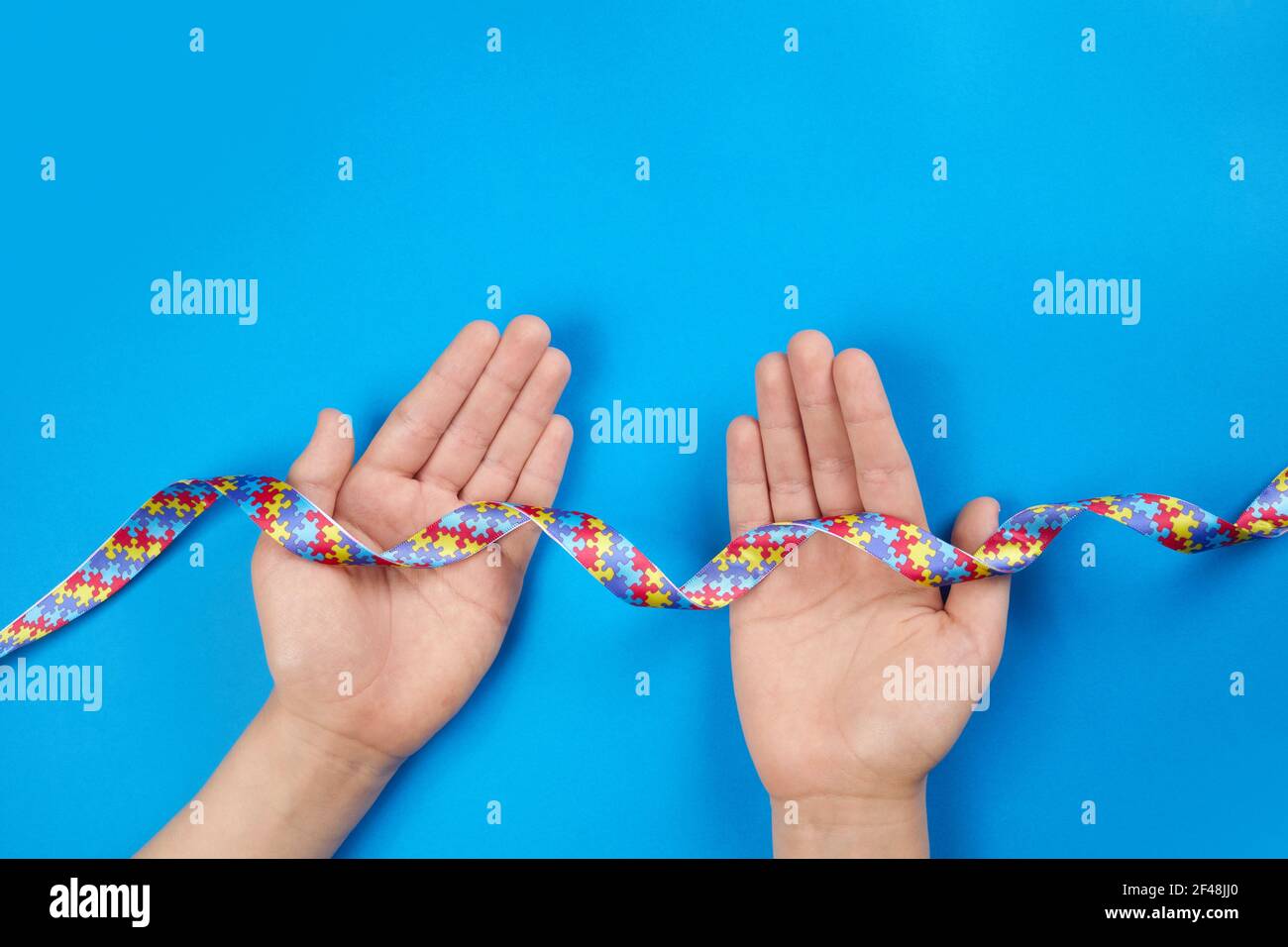 World Autism awareness day. Autistic boy hands holding puzzle pattern ...