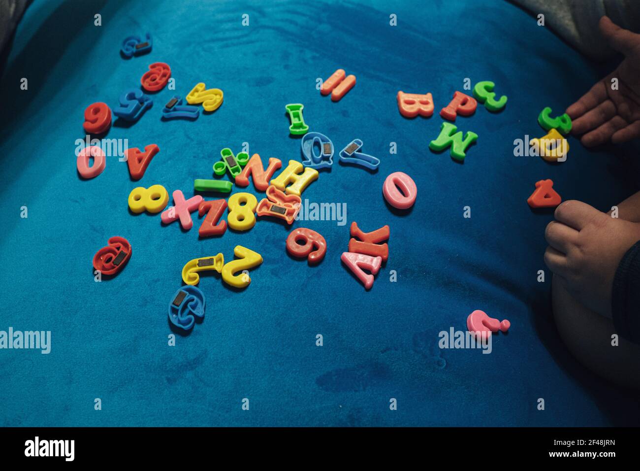A high-angle shot of plastic magnetic numbers and letters of the Latin ...