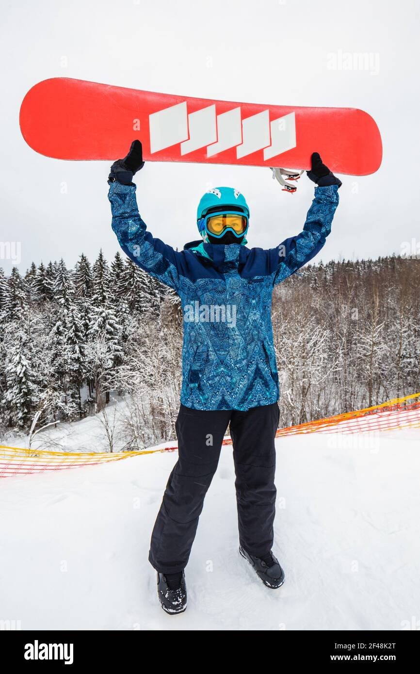 Person with a snowboard on the ski resort Stock Photo - Alamy