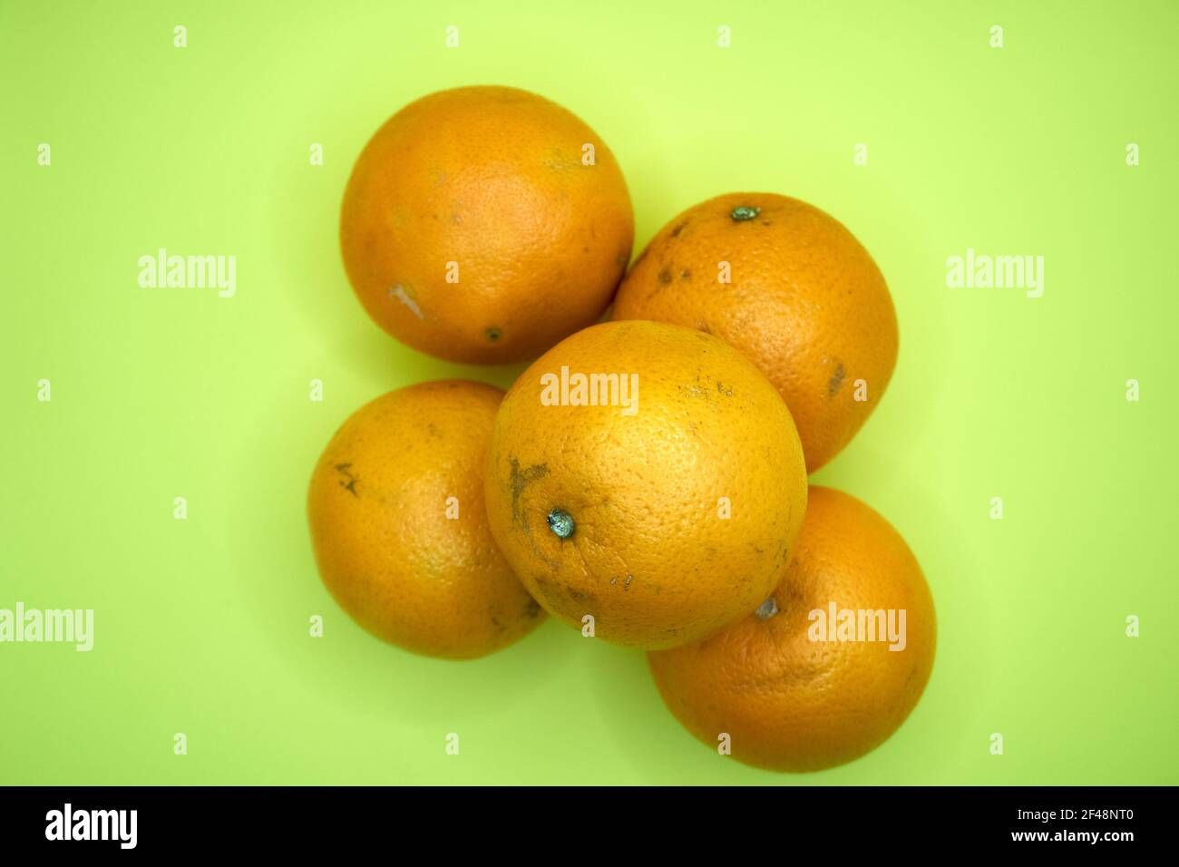A top view closeup of multiple tangerines stacked on each other on a ...