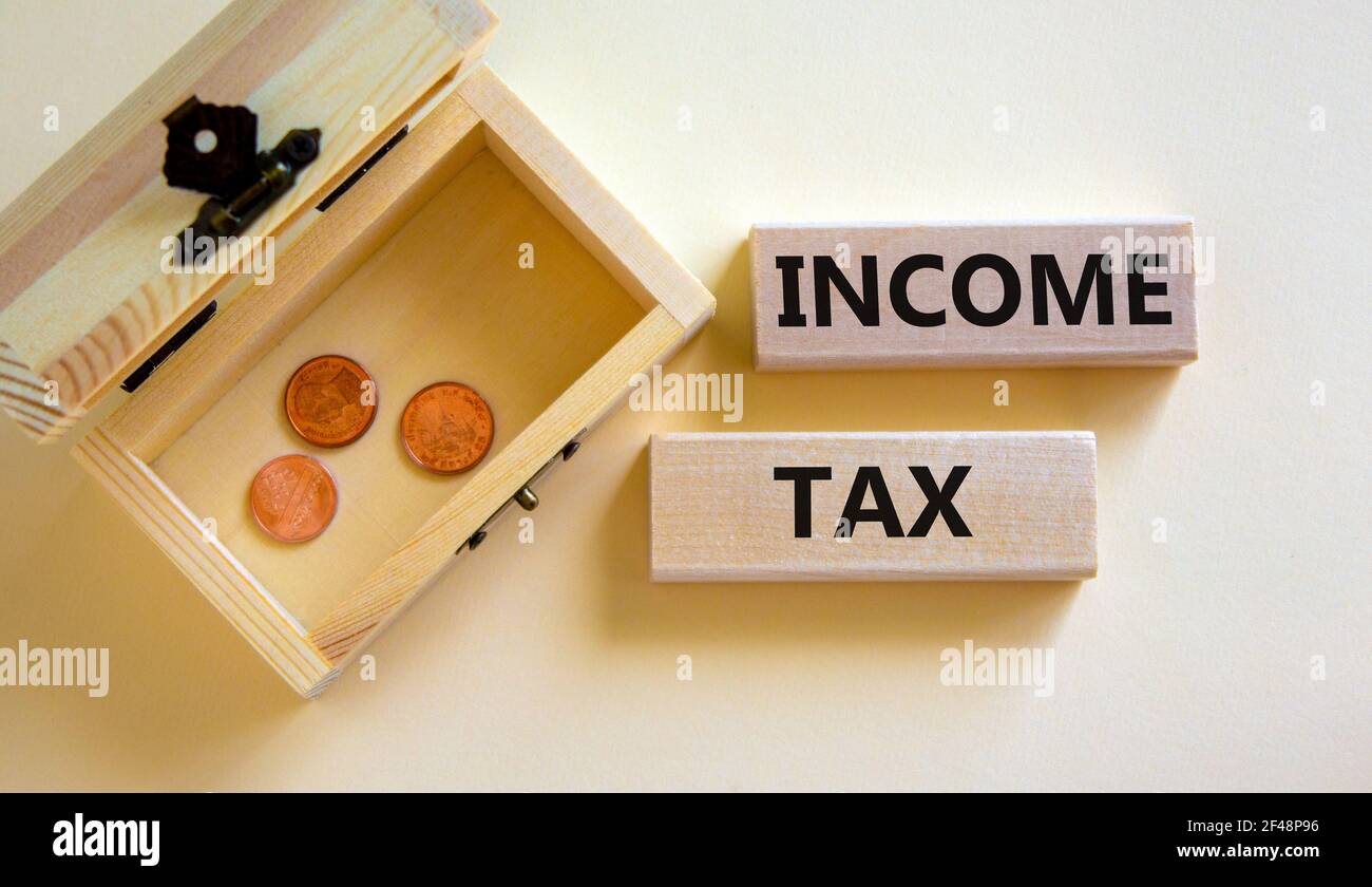 Income tax symbol. Concept words 'income tax' on wooden blocks on a ...