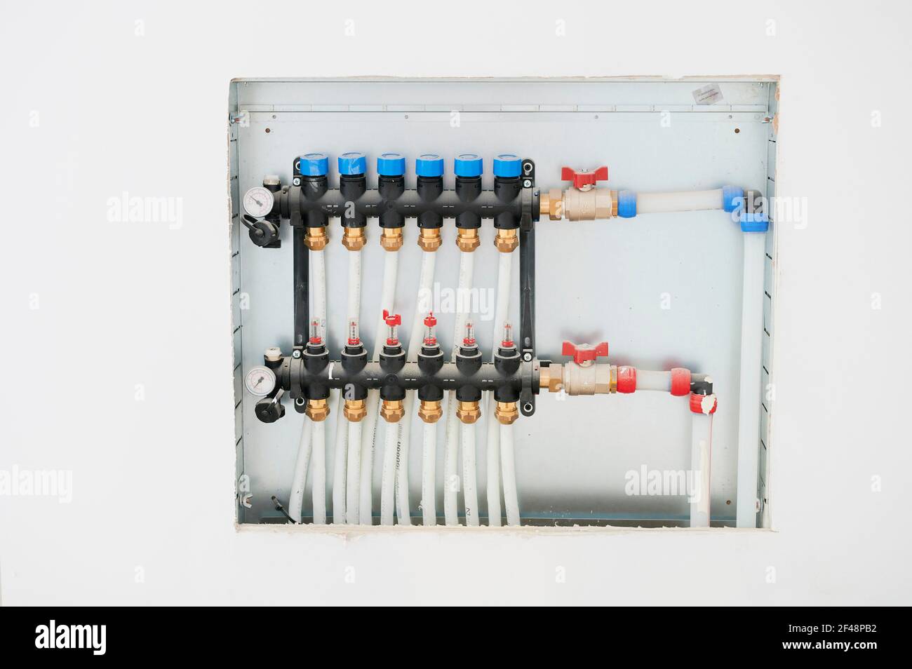 New manifold of underfloor heating system, plastic pipes and valves ...