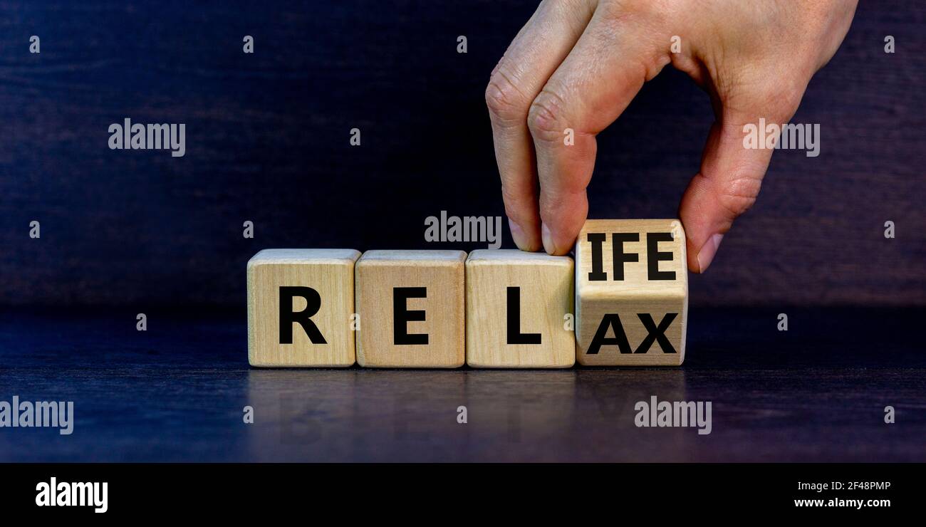 Relief and relax symbol. Businessman turns a cube and changes the word ...