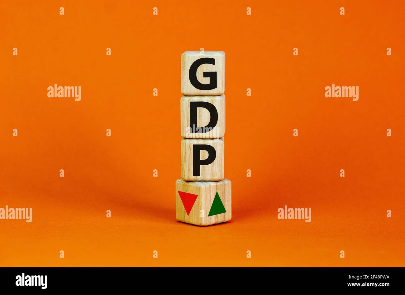 GDP, gross domestic product symbol. Wooden cubes with up and down icon ...