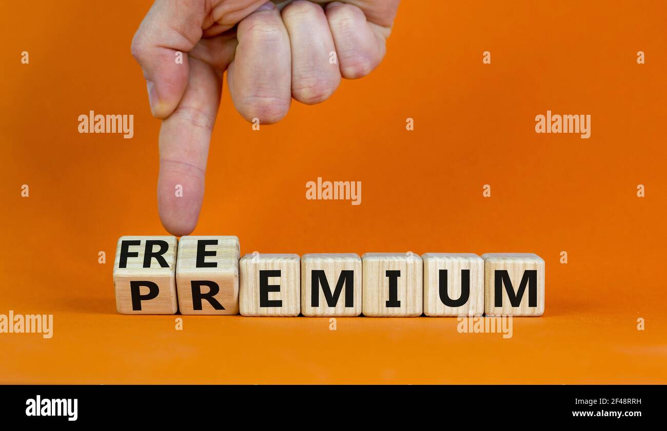 Premium or freemium symbol. Businessman turns wooden cubes and changes ...