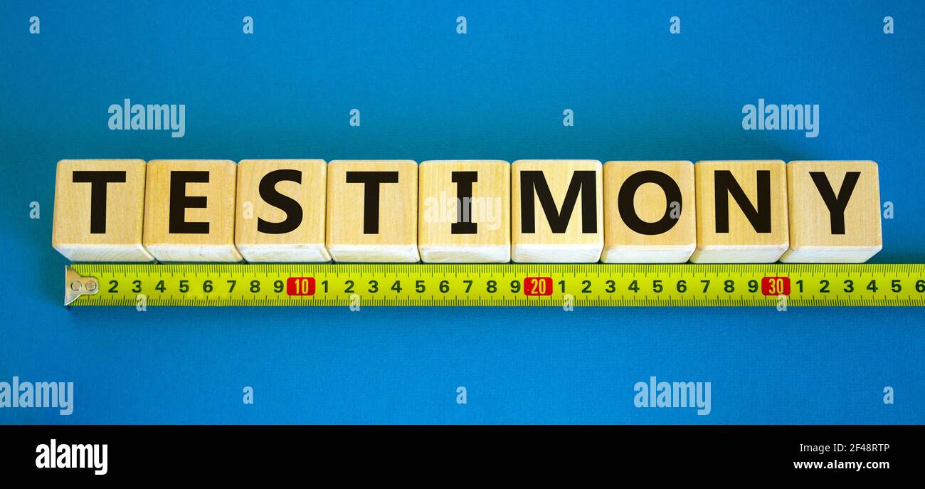 Testimony symbol. Wooden cubes with the word 'testimony' behind yellow ...