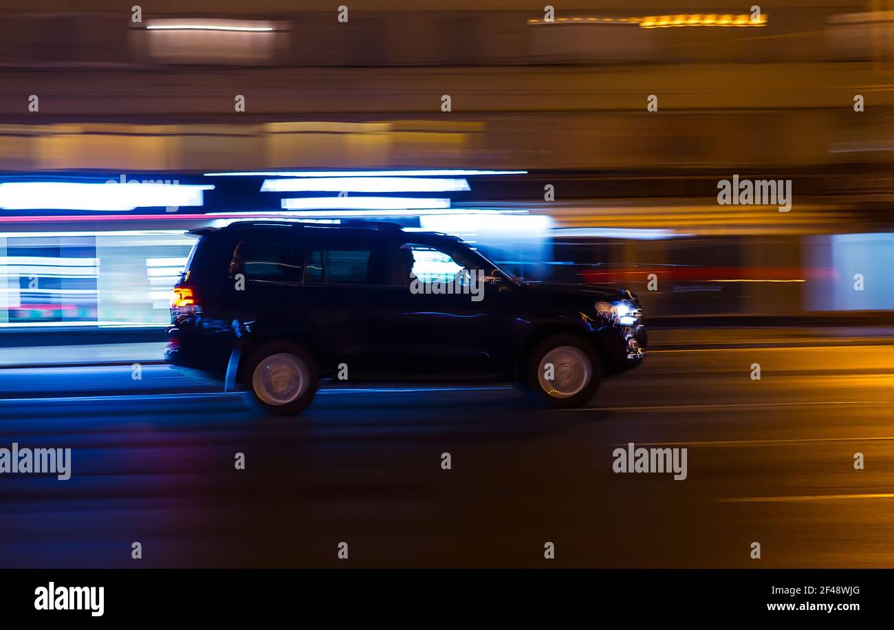 off-road car racing through the night Avenue. Blurred motion Stock ...