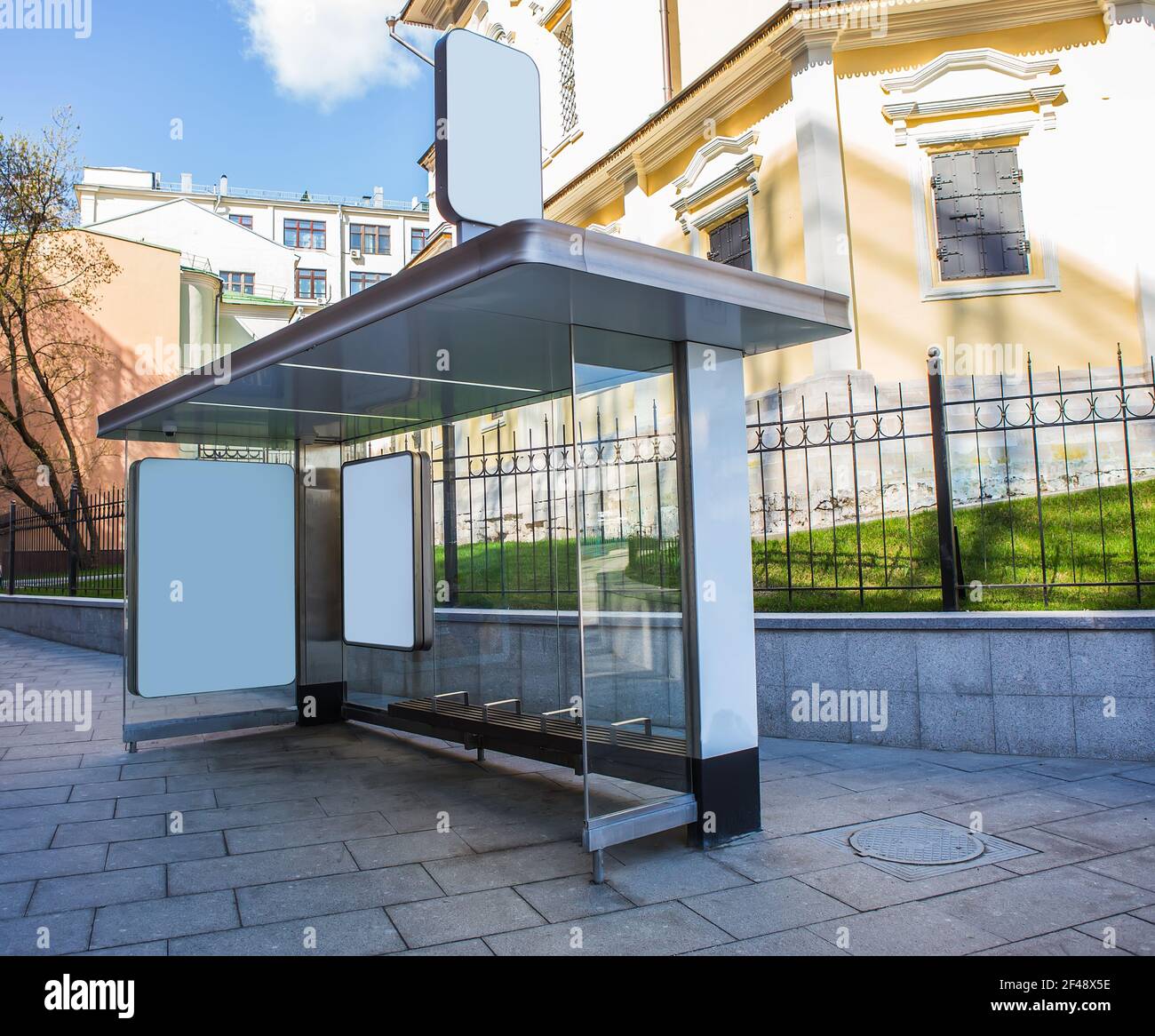 modern glass bus stop with advertising banners Stock Photo - Alamy