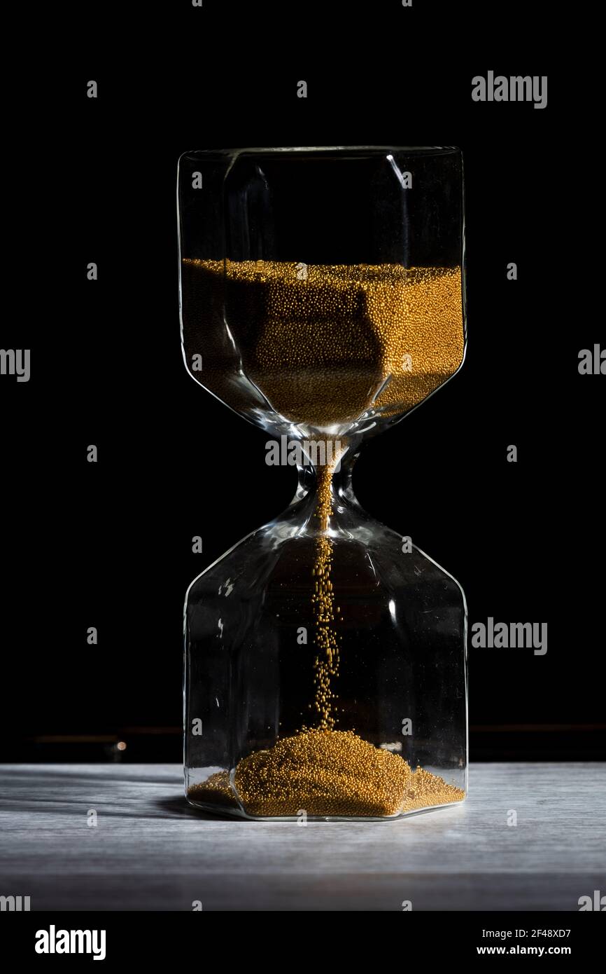hourglass of time isolated on black background Stock Photo - Alamy