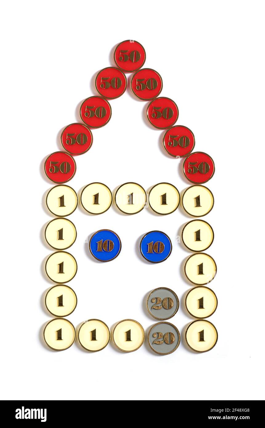 A vertical shot of a house-made from tokens isolated on white ...