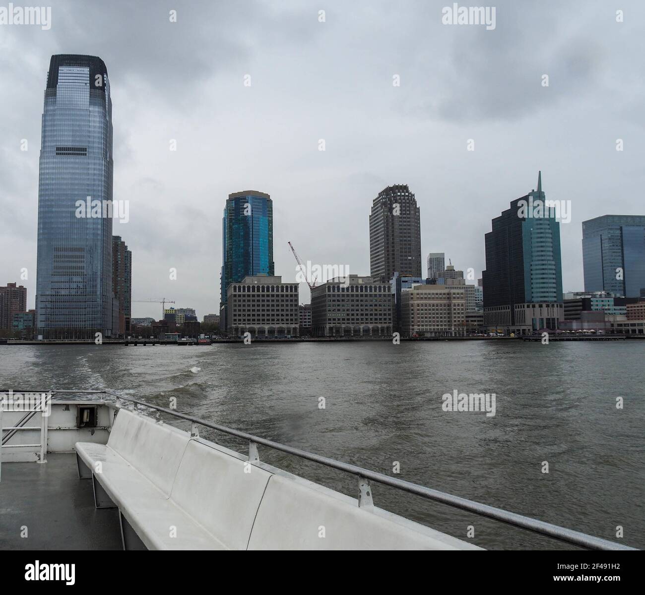 The modern skyscrapers seen from a sailing boat under the cloudy sky in ...