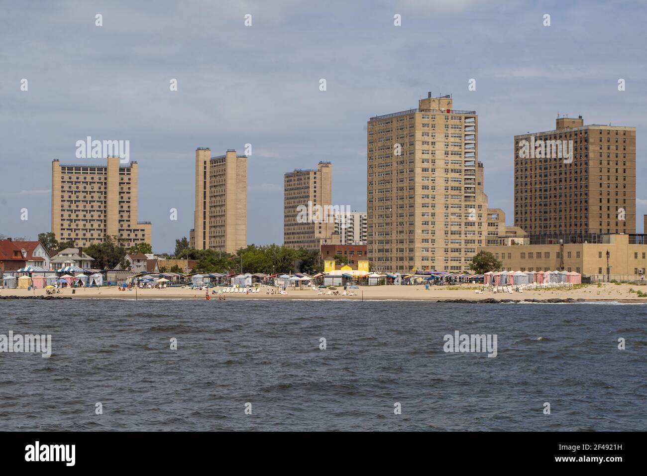 A beach near buildings under a cloudy sky on a gloomy day Stock Photo ...