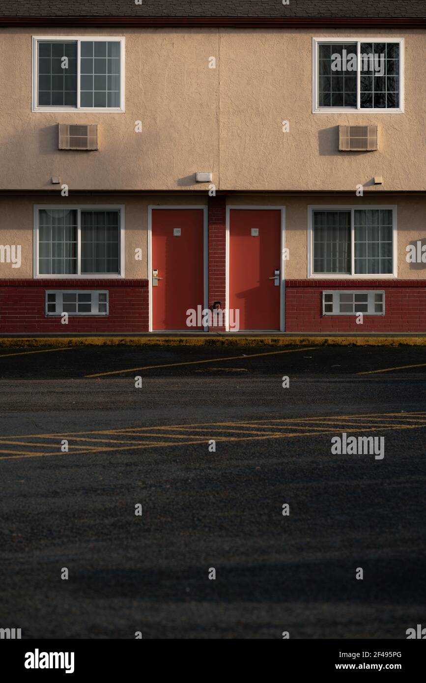 A vertical shot of a building with two identical sides (windows and ...