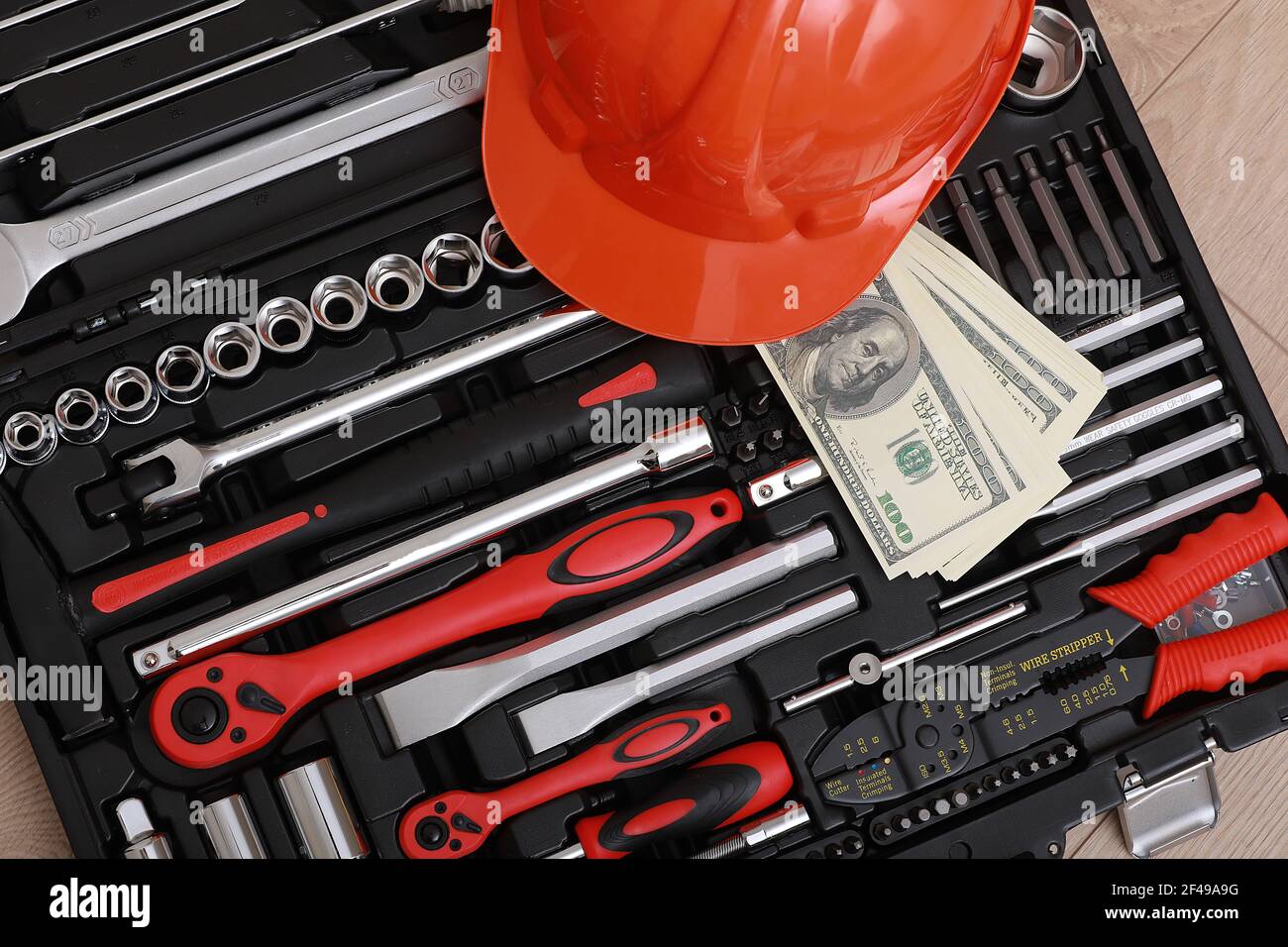 Toolbox, tools kit detail, dollar bills and orange protective helmet ...