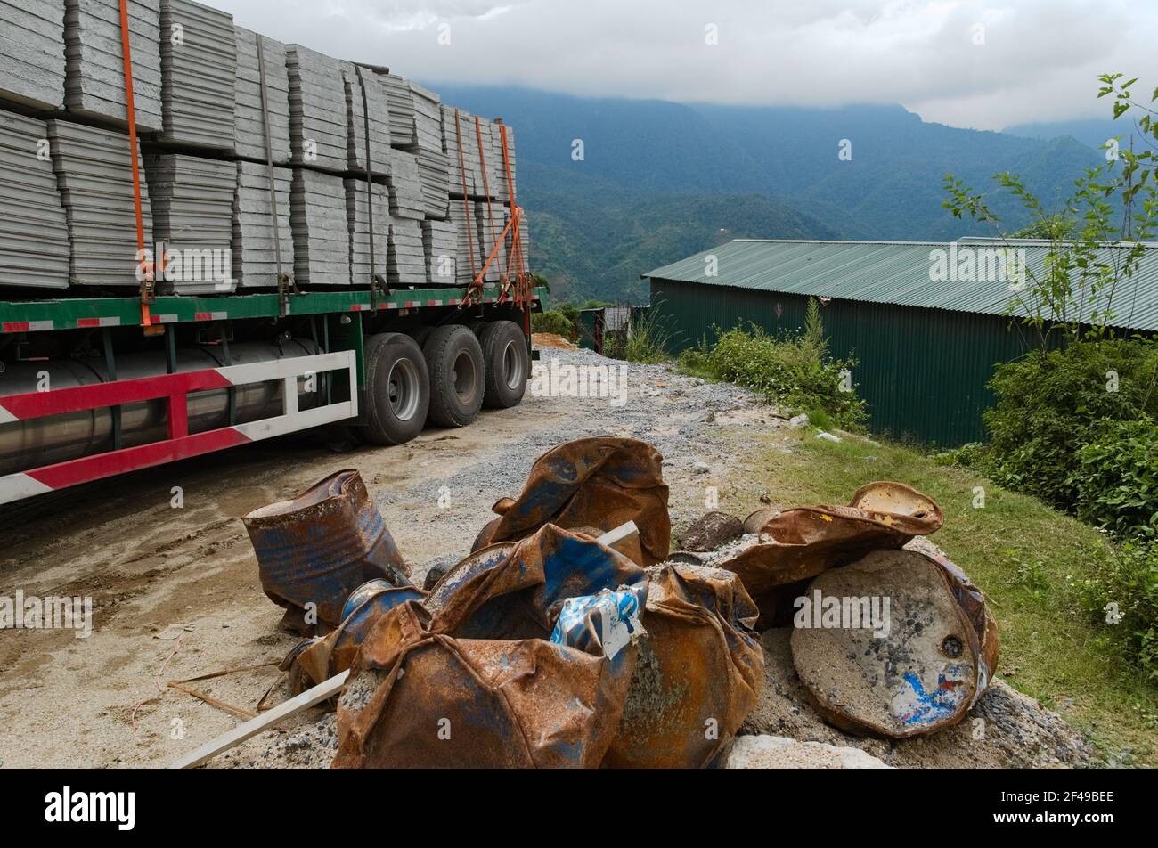 Heavy freight truck with concrete blocks stay neat heap of garbage ...