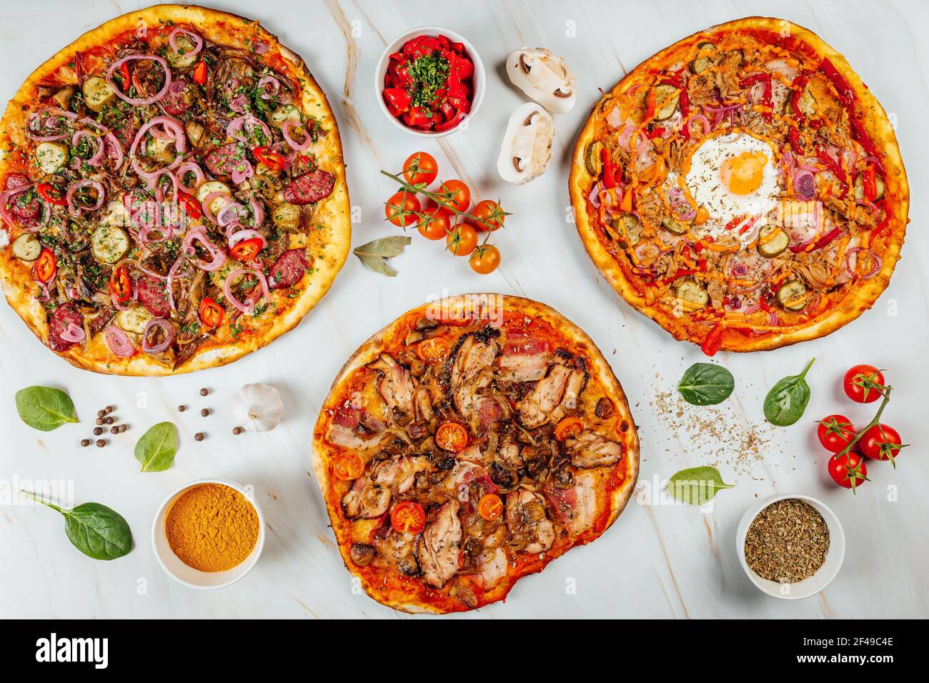 A top view of various tasty pizzas and spices Stock Photo - Alamy
